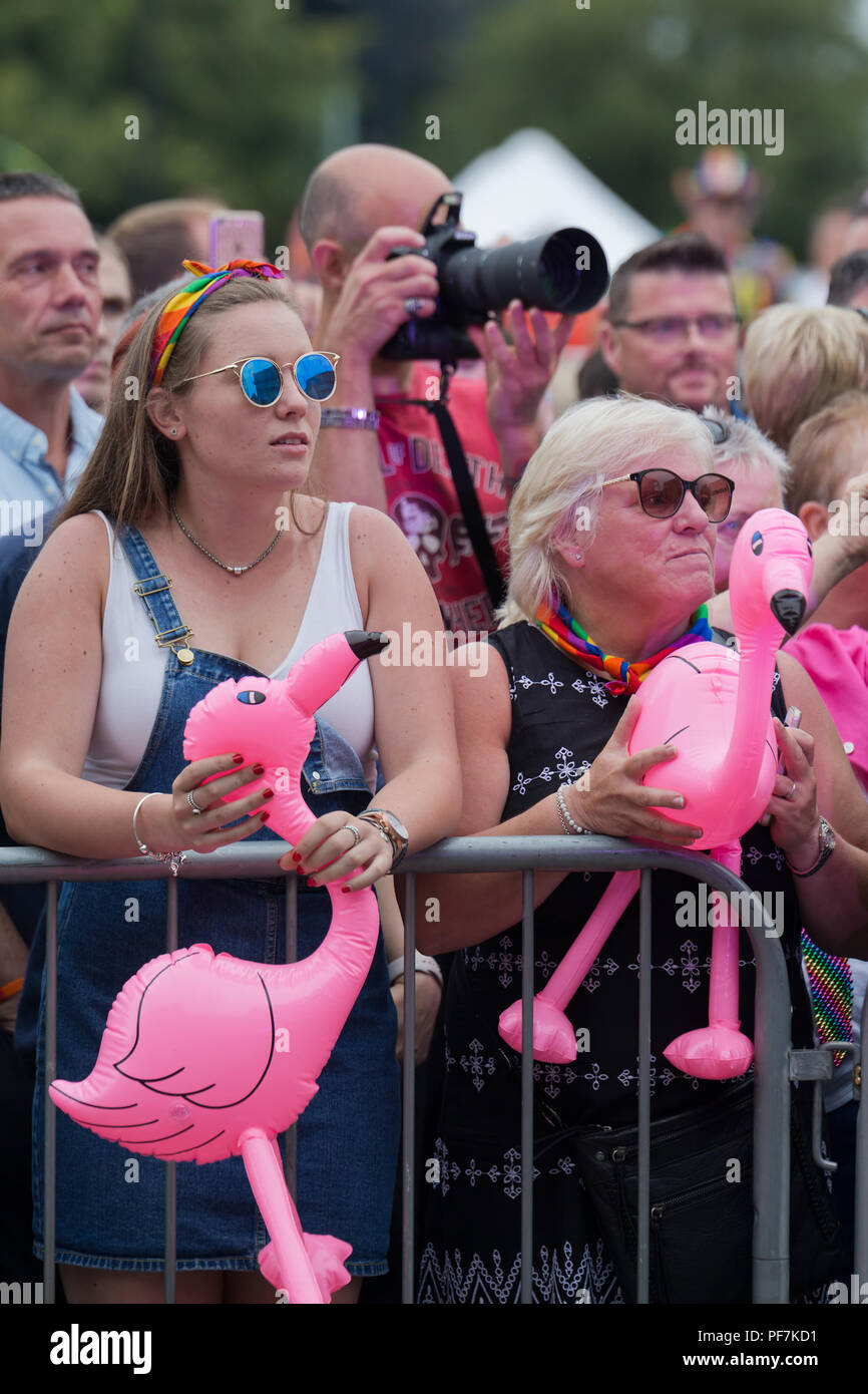 Two women in the crowd holding Pink Flamingo inflatables at the 2018 ...