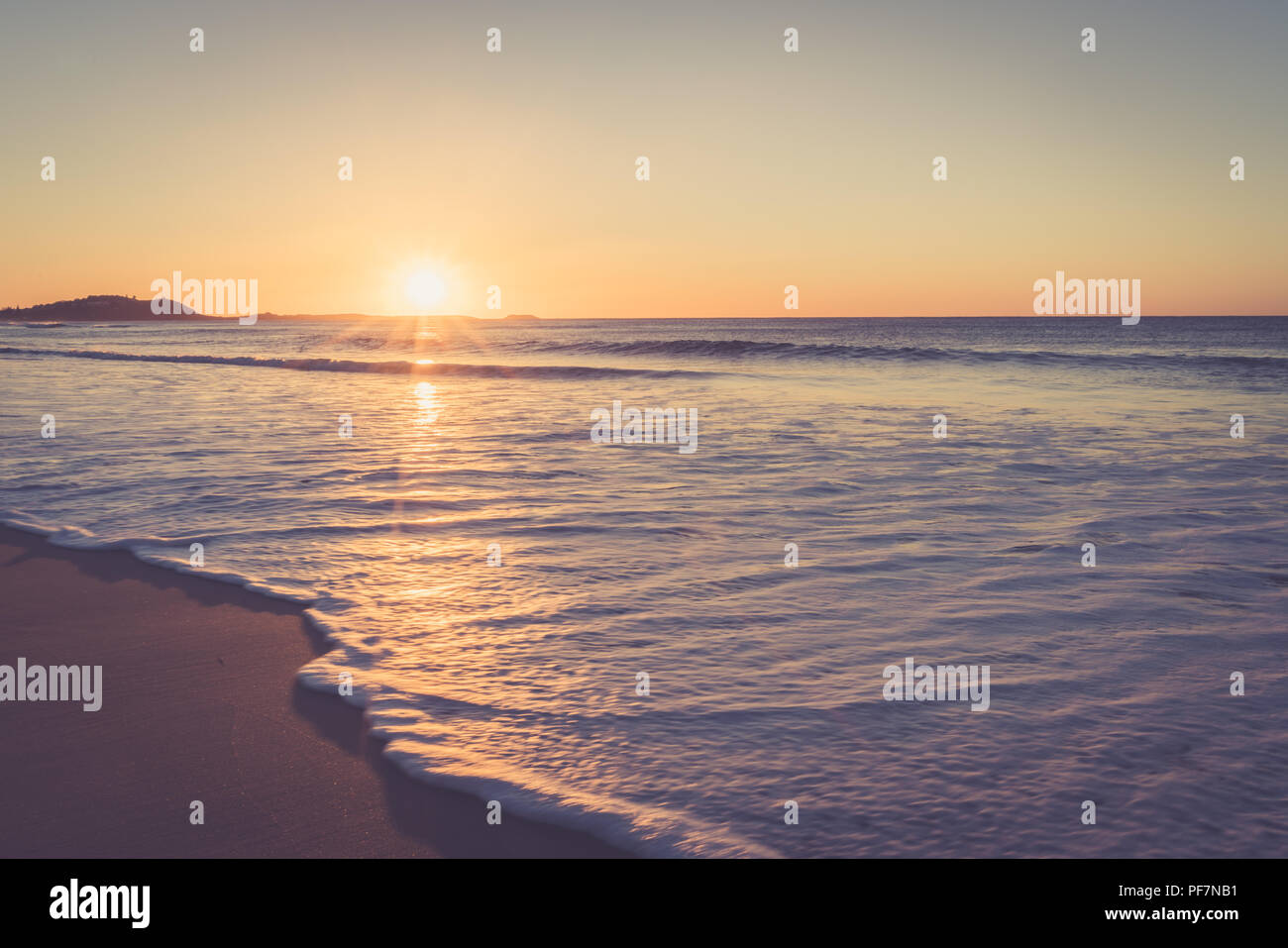 Soft, warm sunrise at the beach Stock Photo - Alamy