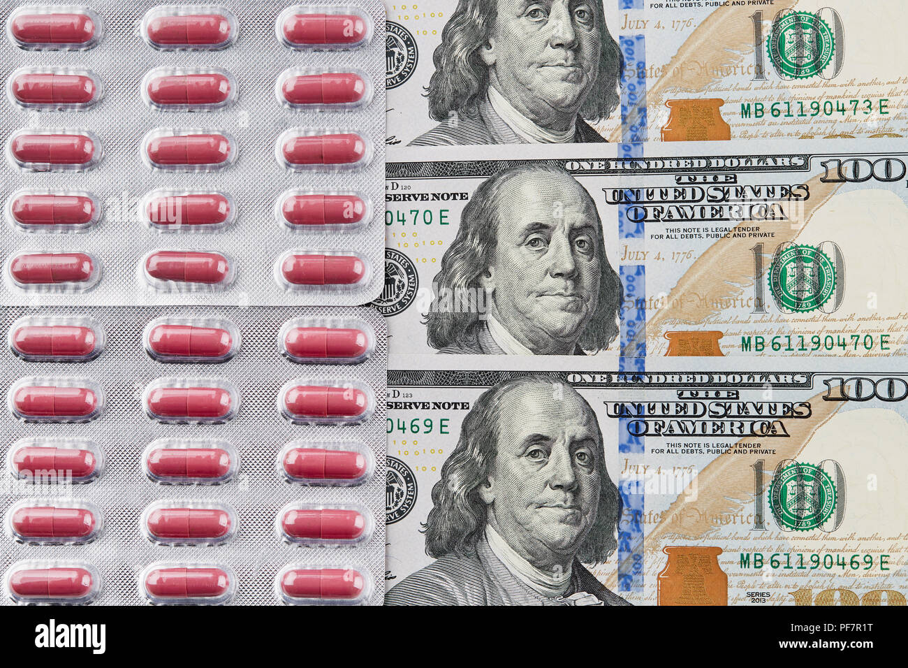 Red pills lie on american dollars banknote Stock Photo - Alamy