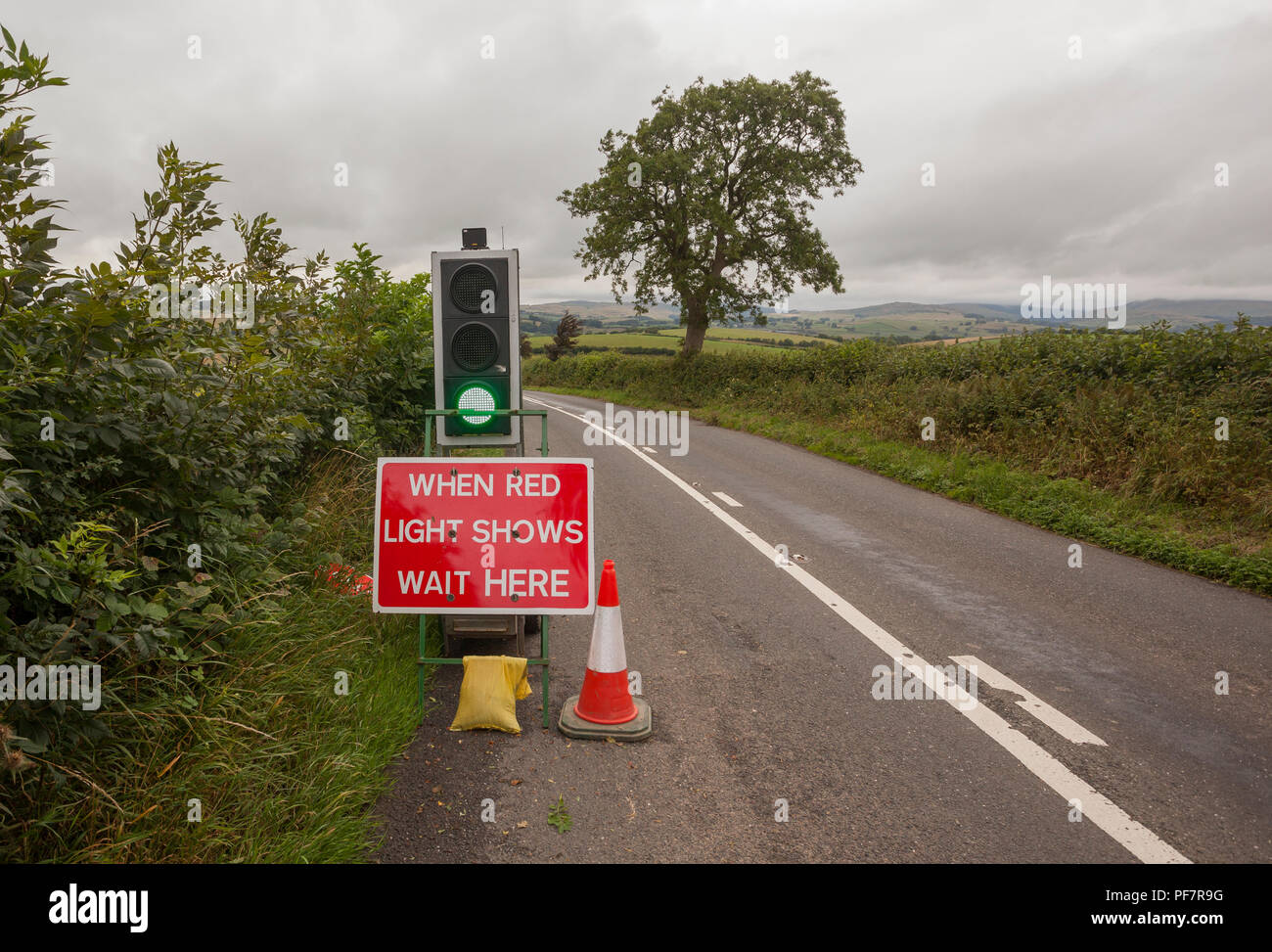 'When Red Light shows wait here' sign during roadworks on a country ...