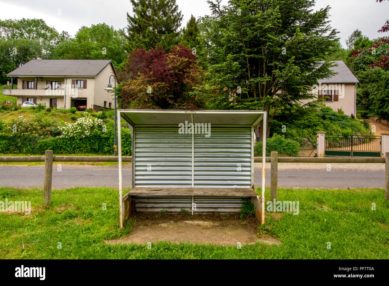 Wooden bench of soccer players along a stadium in a countryside village ...