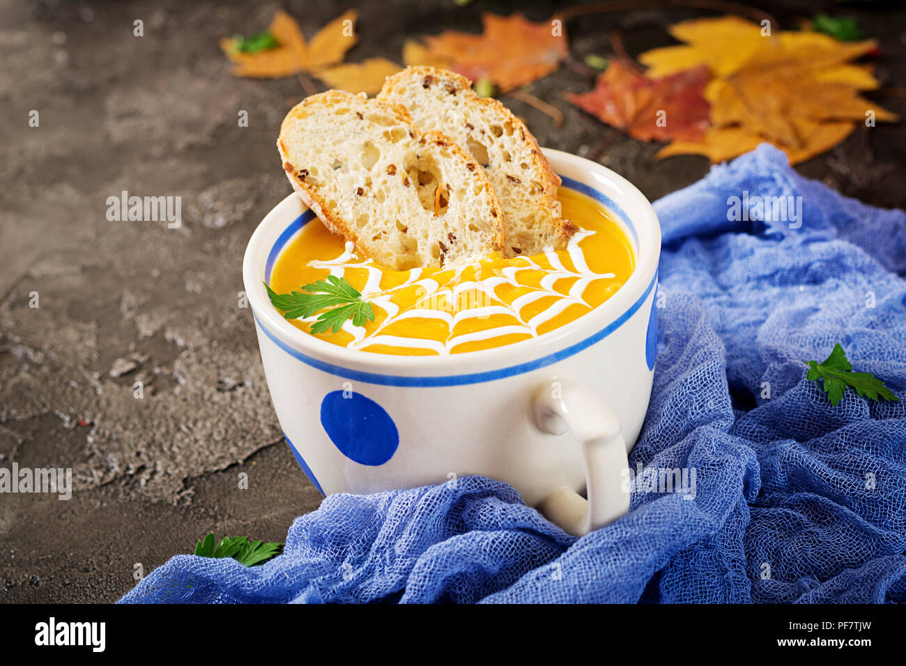Pumpkin soup in a bowl served with parsley and pumpkin seeds. Vegan ...