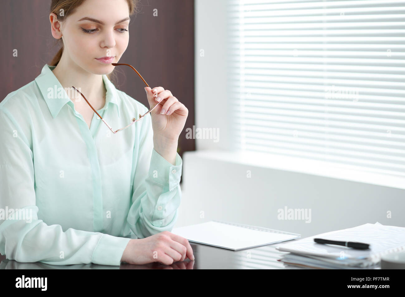 Business woman or secretary sitting at the desk in the office. Green ...