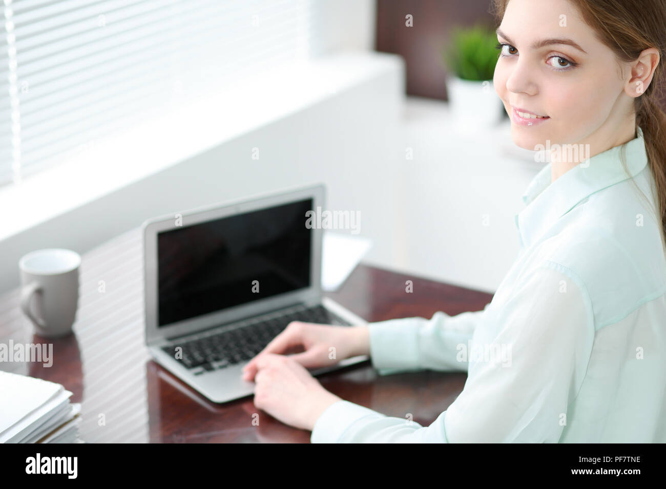 Business woman or secretary sitting at the desk in the office. Green ...