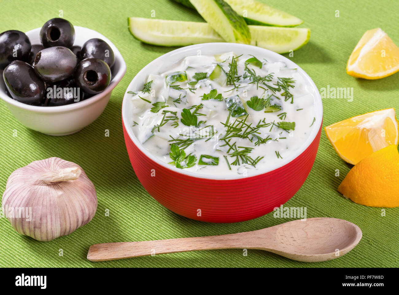 fresh tzatziki in a red bowl and ingredients, view from the height of a ...