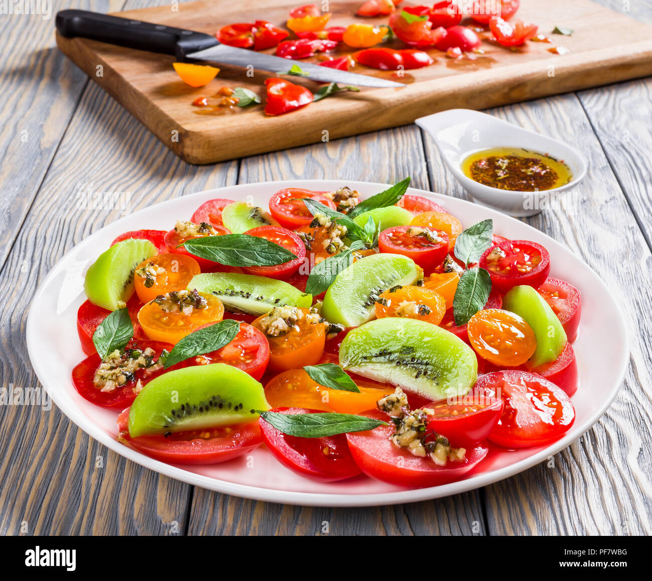 tomatoes, kiwi fruit, mint salad dressed with shredded cheese brie ...