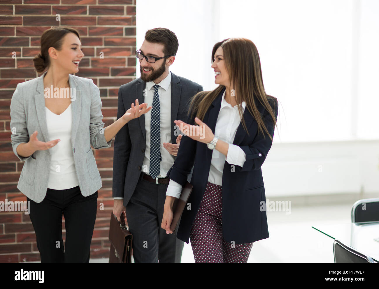 business team talking standing in the office Stock Photo - Alamy