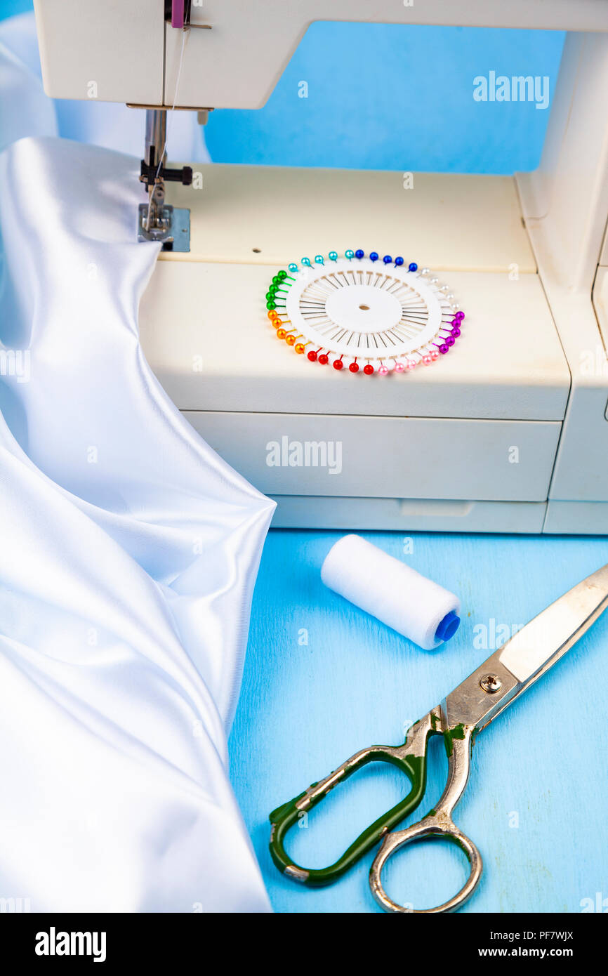 Sewing machine and white satin fabric close-up Stock Photo - Alamy