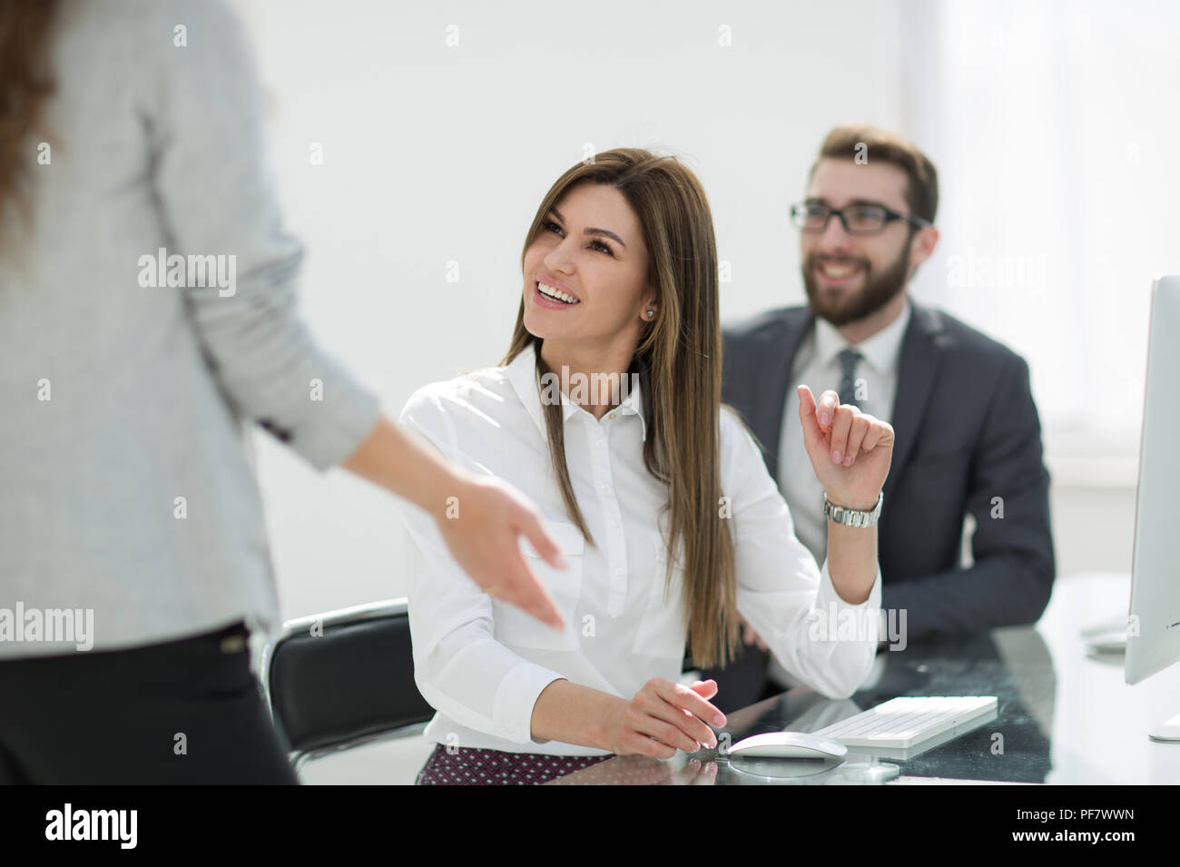 smiling employees talking in the workplace Stock Photo - Alamy