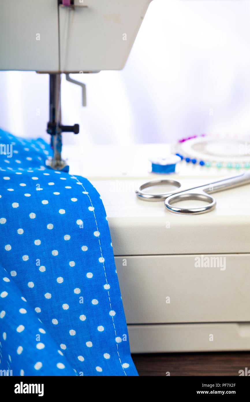 Sewing machine and blue fabric close-up Stock Photo - Alamy