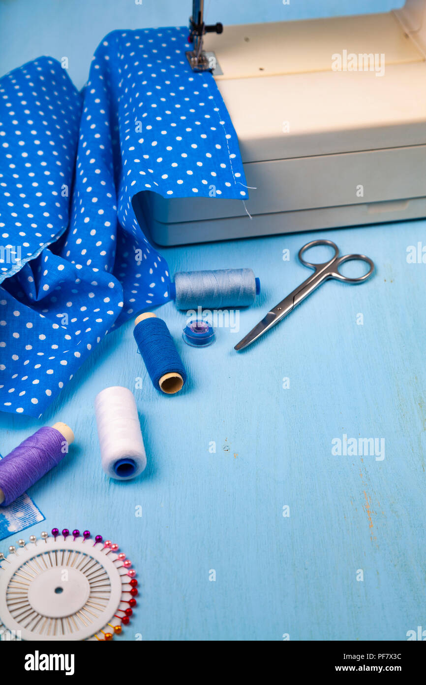 Sewing machine and blue fabric close-up Stock Photo - Alamy