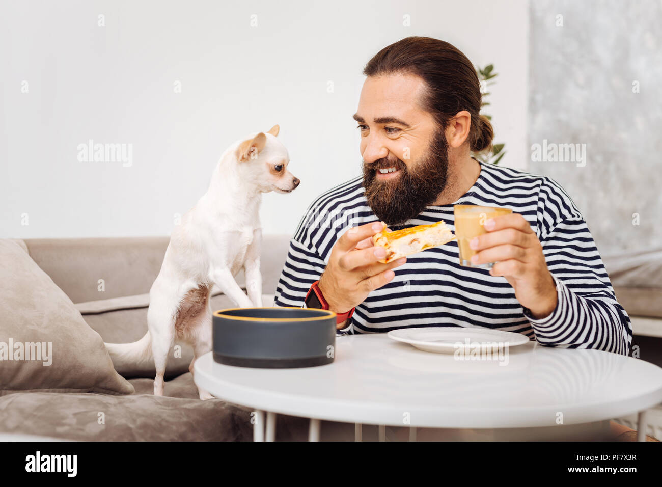 Bearded man eating cheesecake and drinking latte Stock Photo - Alamy