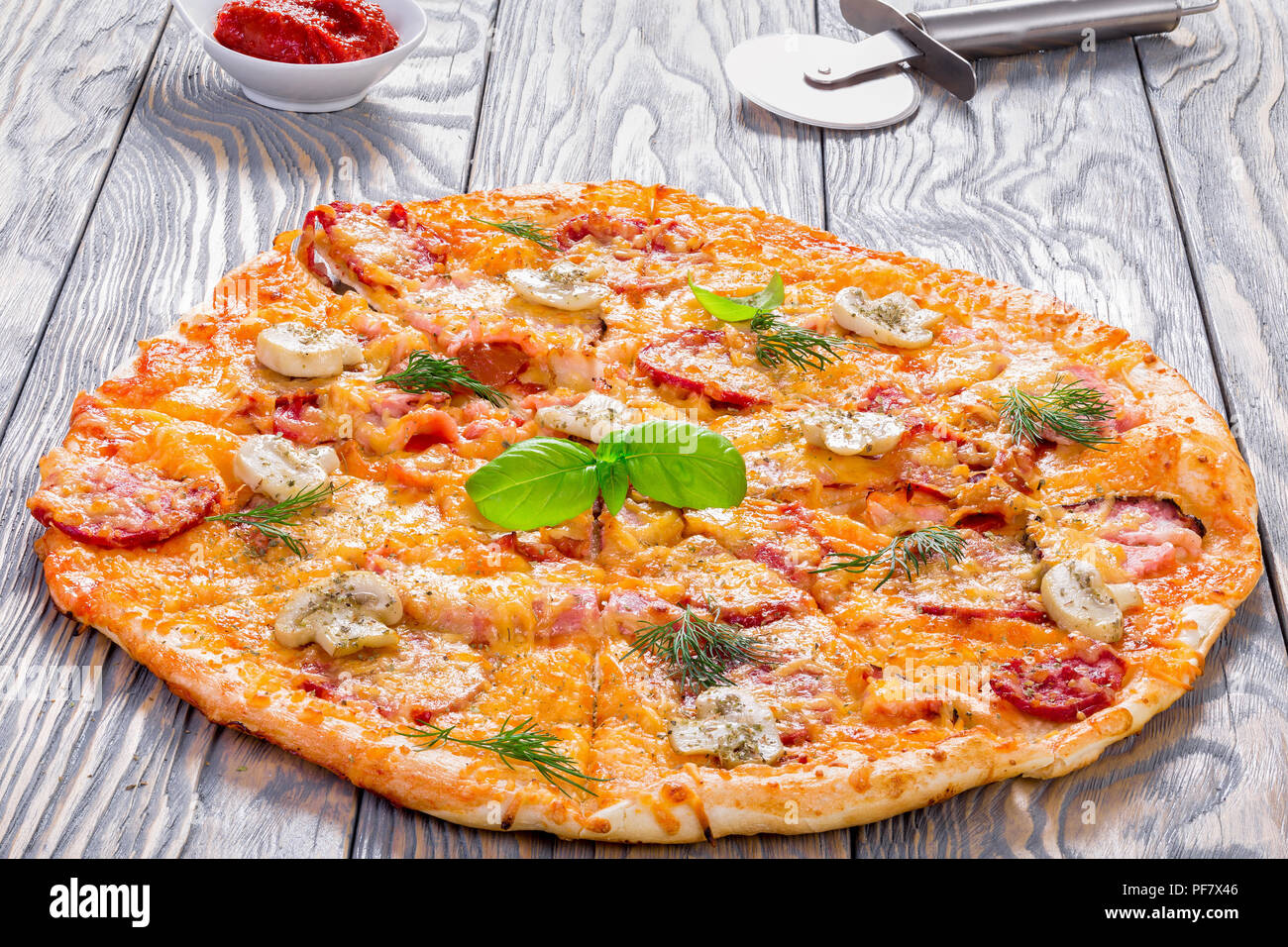 pizza with sausage, ham, mushrooms and cheese, close-up Stock Photo - Alamy