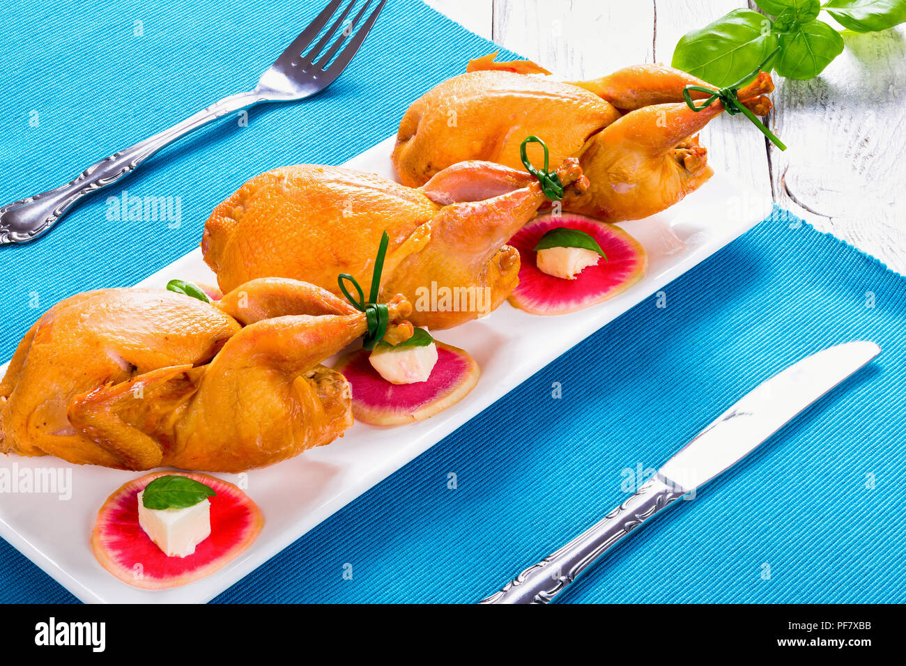 smoked quail on a rectangular dish, close-up Stock Photo - Alamy