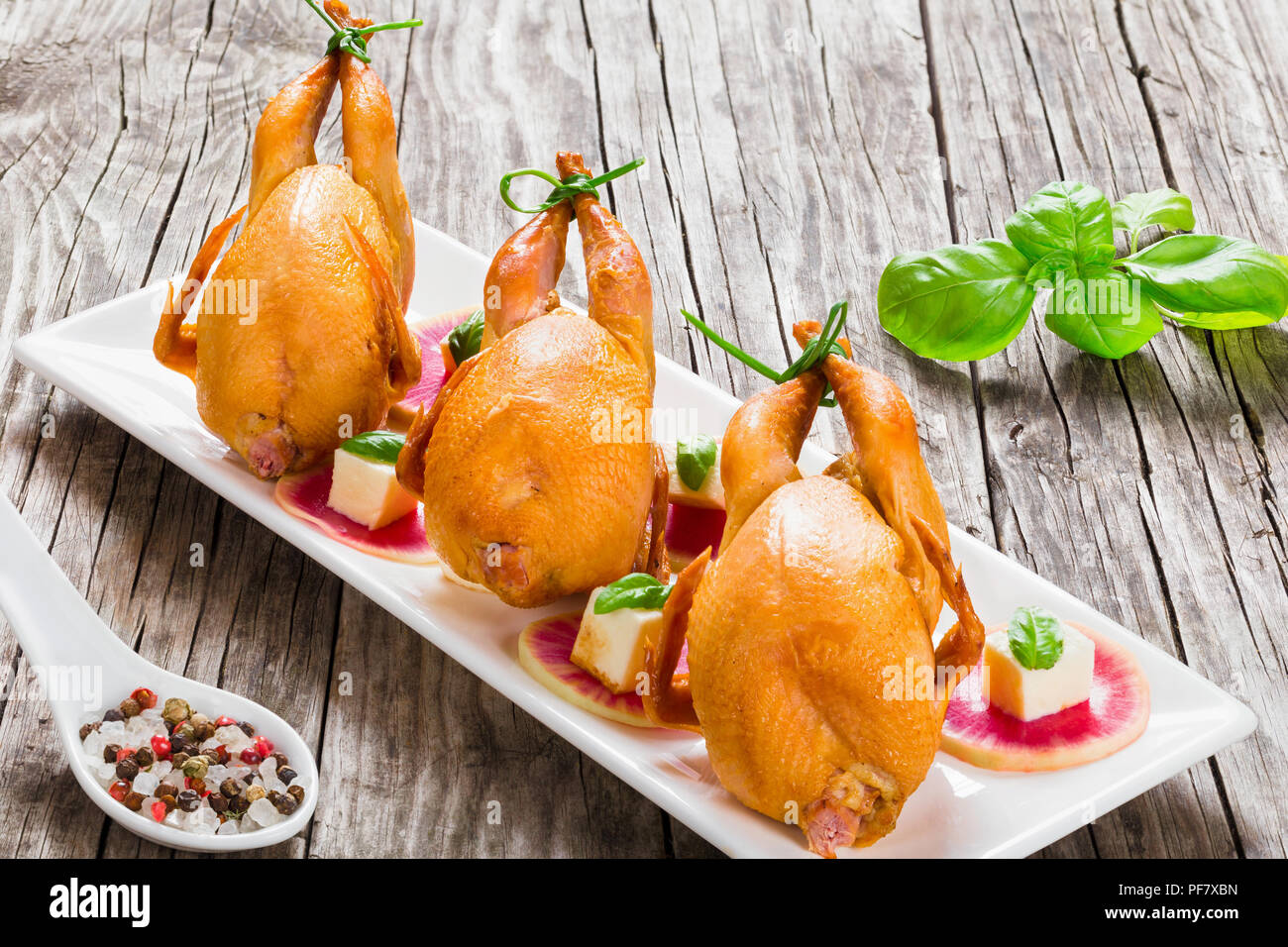 smoked quail on a rectangular dish, close-up Stock Photo - Alamy