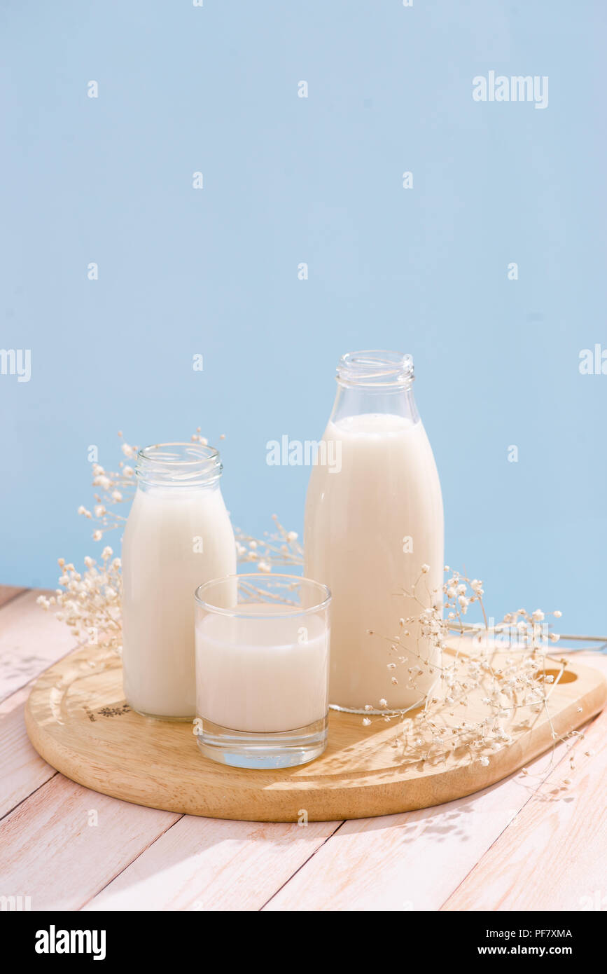 Dairy products. Bottle with milk and glass of milk on wooden table ...