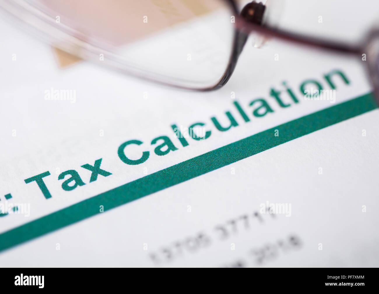 Tax Calculation statement paper with envelopes and reading glasses ...