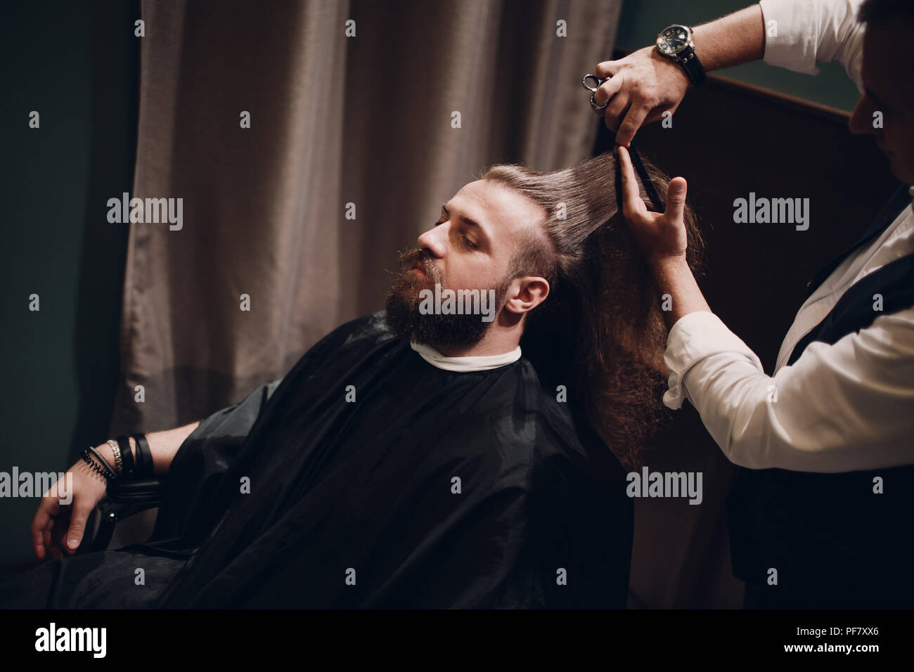Barbershop with wooden interior. Bearded model man and barber Stock ...