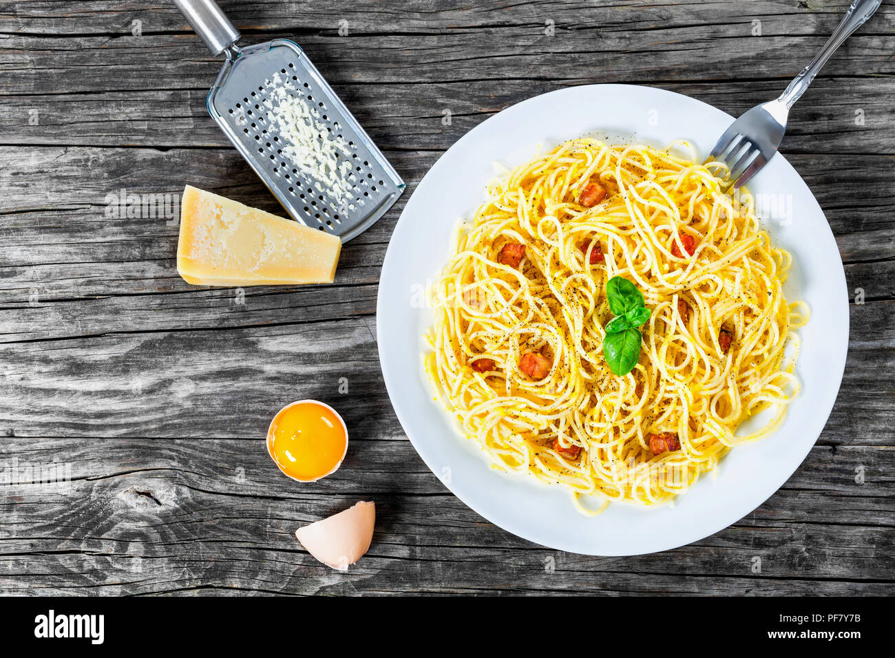 Spaghetti carbonara, basil, eggs yolk, grated parmesan cheese, bacon ...