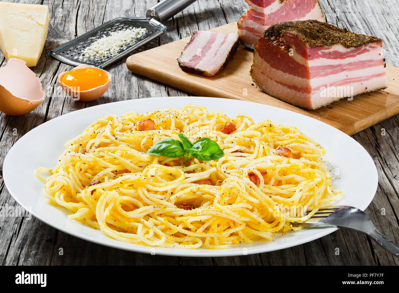 Spaghetti carbonara, basil, eggs yolk, grated parmesan cheese, bacon ...