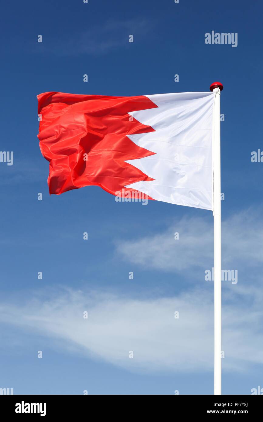 Flag of Bahrain waving in the sky Stock Photo - Alamy