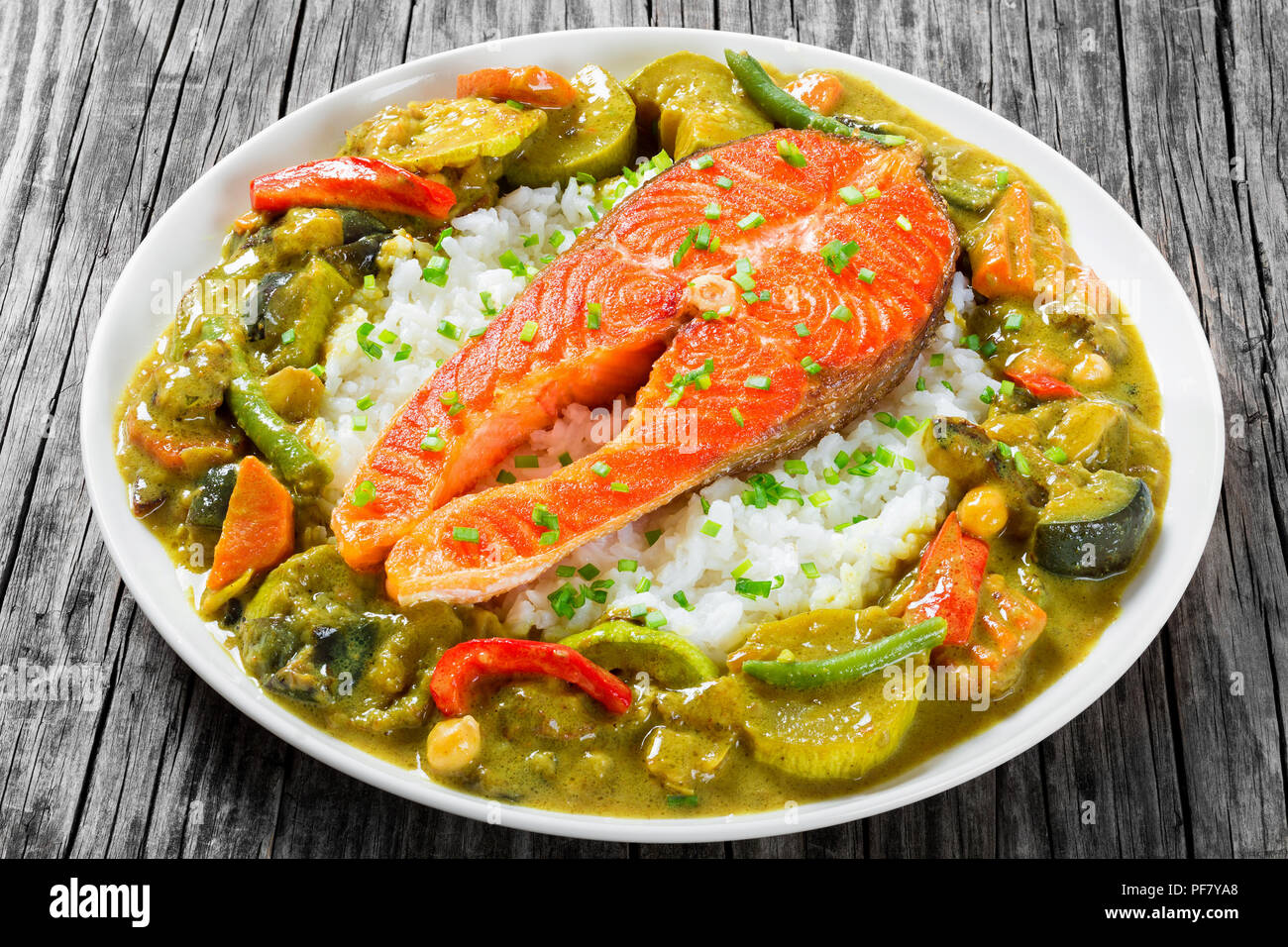 fried steak of red fish with rice and homemade curry Stock Photo - Alamy