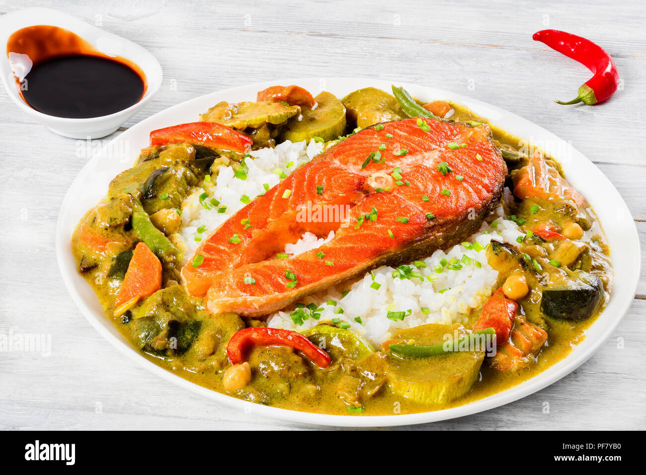 fried steak of red fish with rice and homemade curry Stock Photo - Alamy