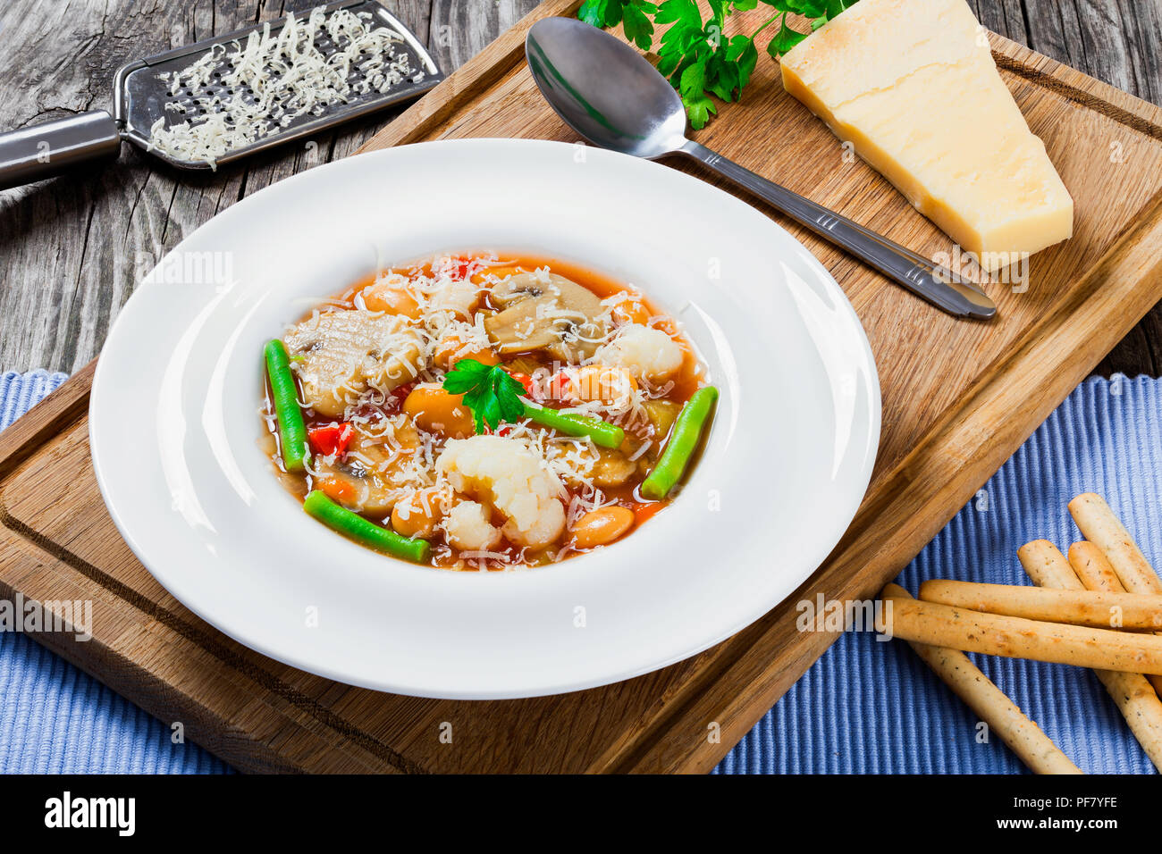 Minestrone vegetable soup with beans, cauliflower, tomatoes, close-up ...