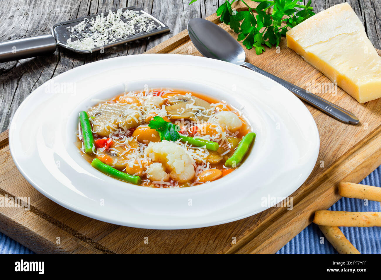 Minestrone vegetable soup with beans, cauliflower, tomatoes, close-up ...