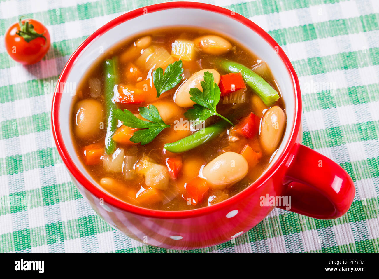 Minestrone vegetable soup with beans, cauliflower, tomatoes, close-up ...