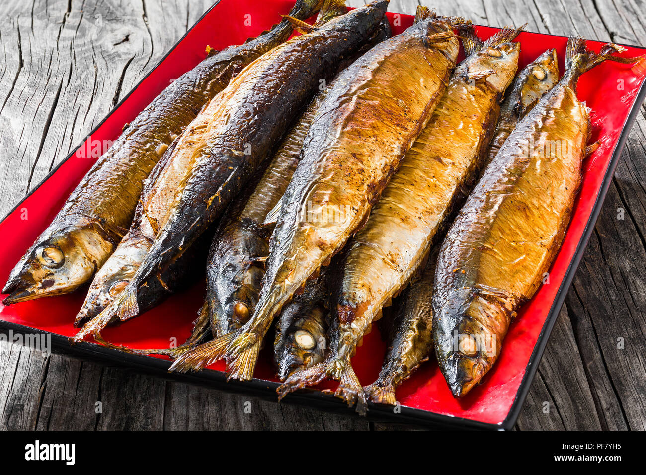 Baked saury on a red rectangular dish , close-up top view Stock Photo ...