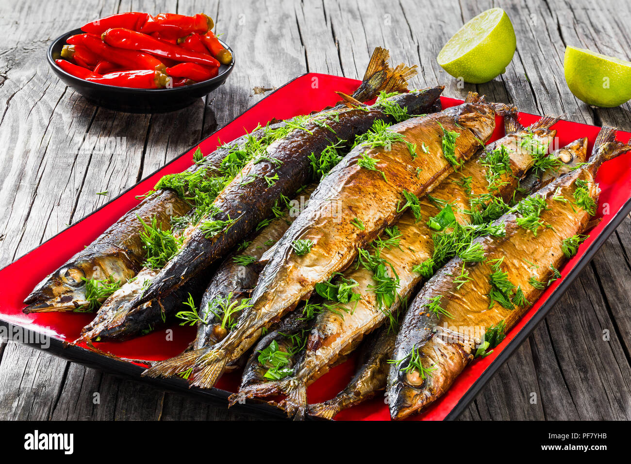 Baked saury on a red rectangular dish , close-up top view Stock Photo ...