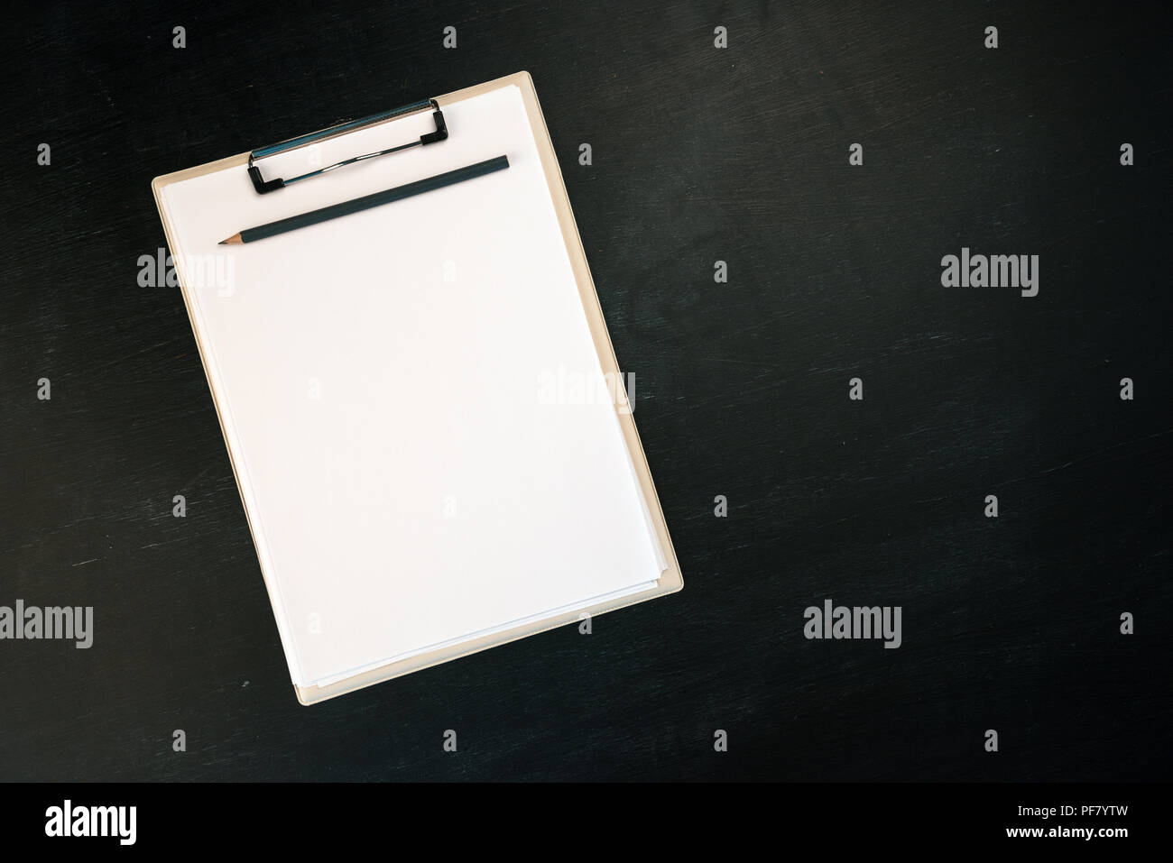 Notes clipboard with pencil and blank sheets of paper as mock up copy ...