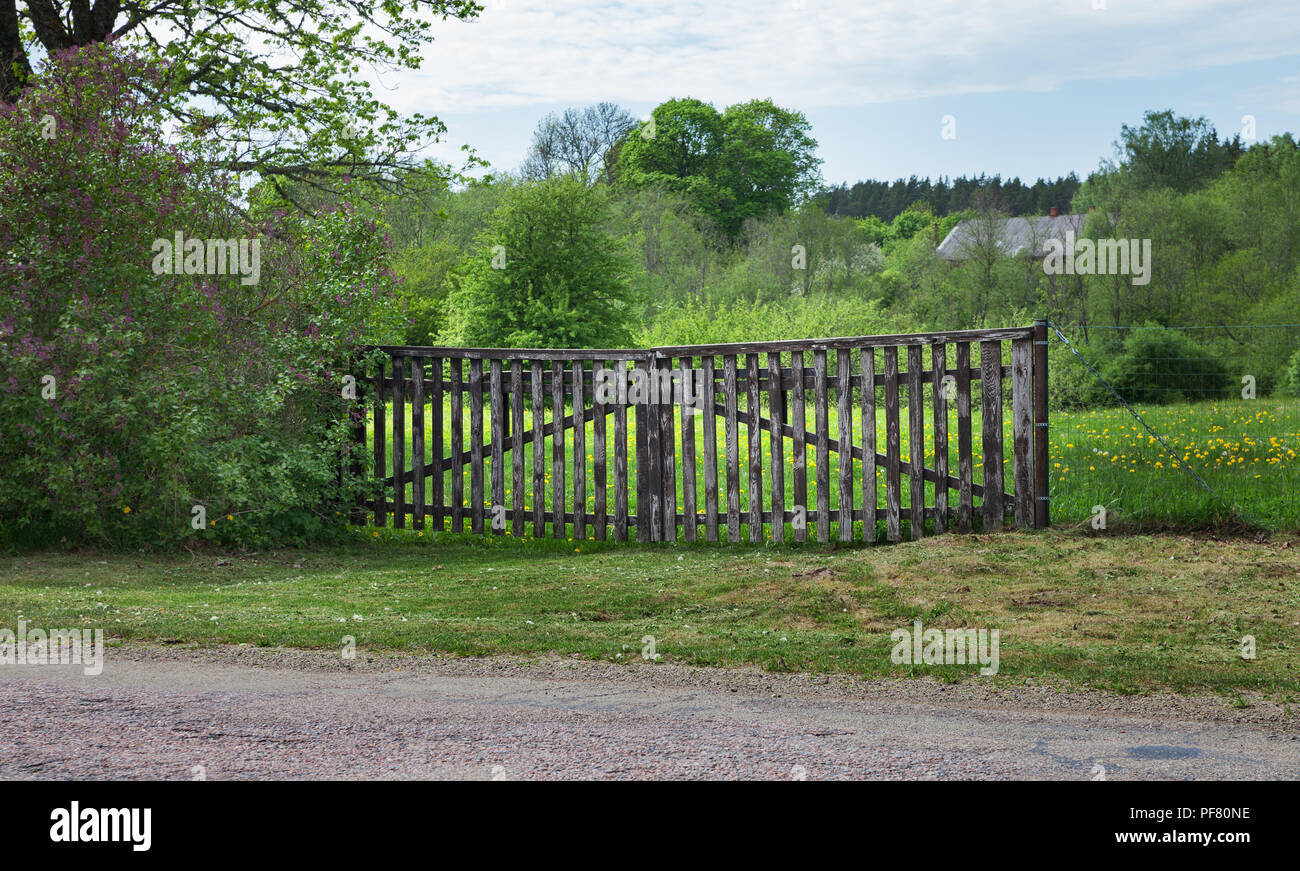 Wooden gate next to the road Stock Photo - Alamy