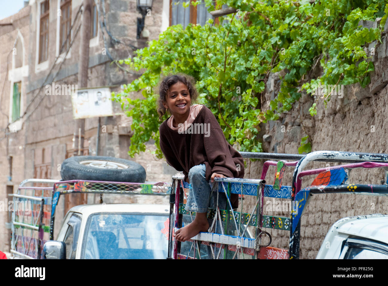 A girl on a vehicle smiles at the camera on May 4, 2007 in Sanaa, Yemen ...