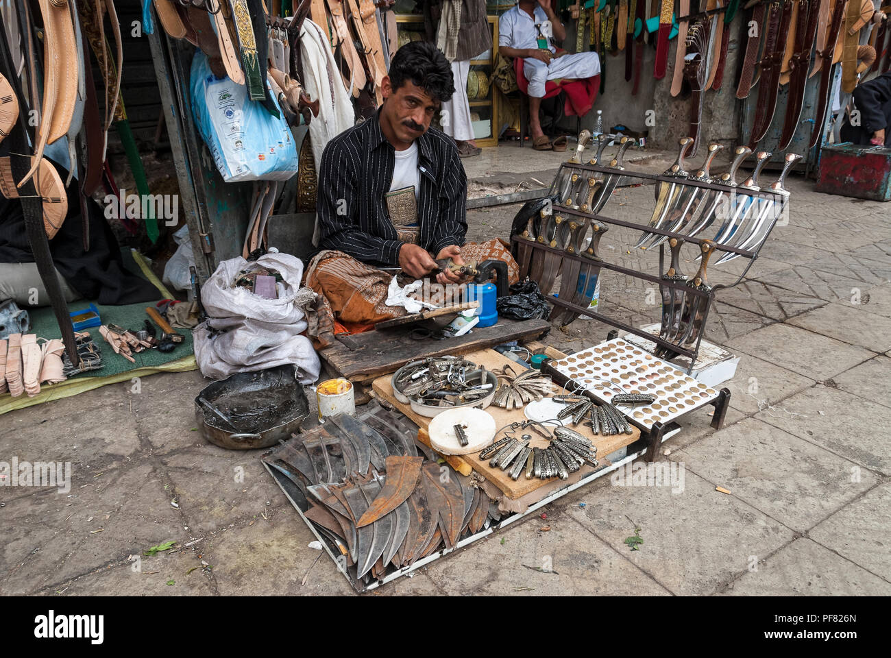 A man sells janbiyas on May 4, 2007 in Sanaa, Yemen. Janbiya is a ...