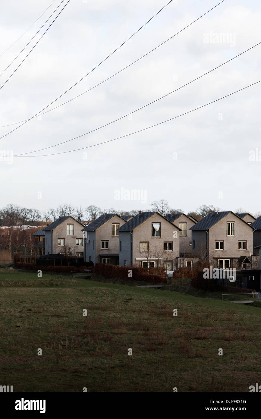 A number of houses in a row near by low hanging power lines Stock Photo ...