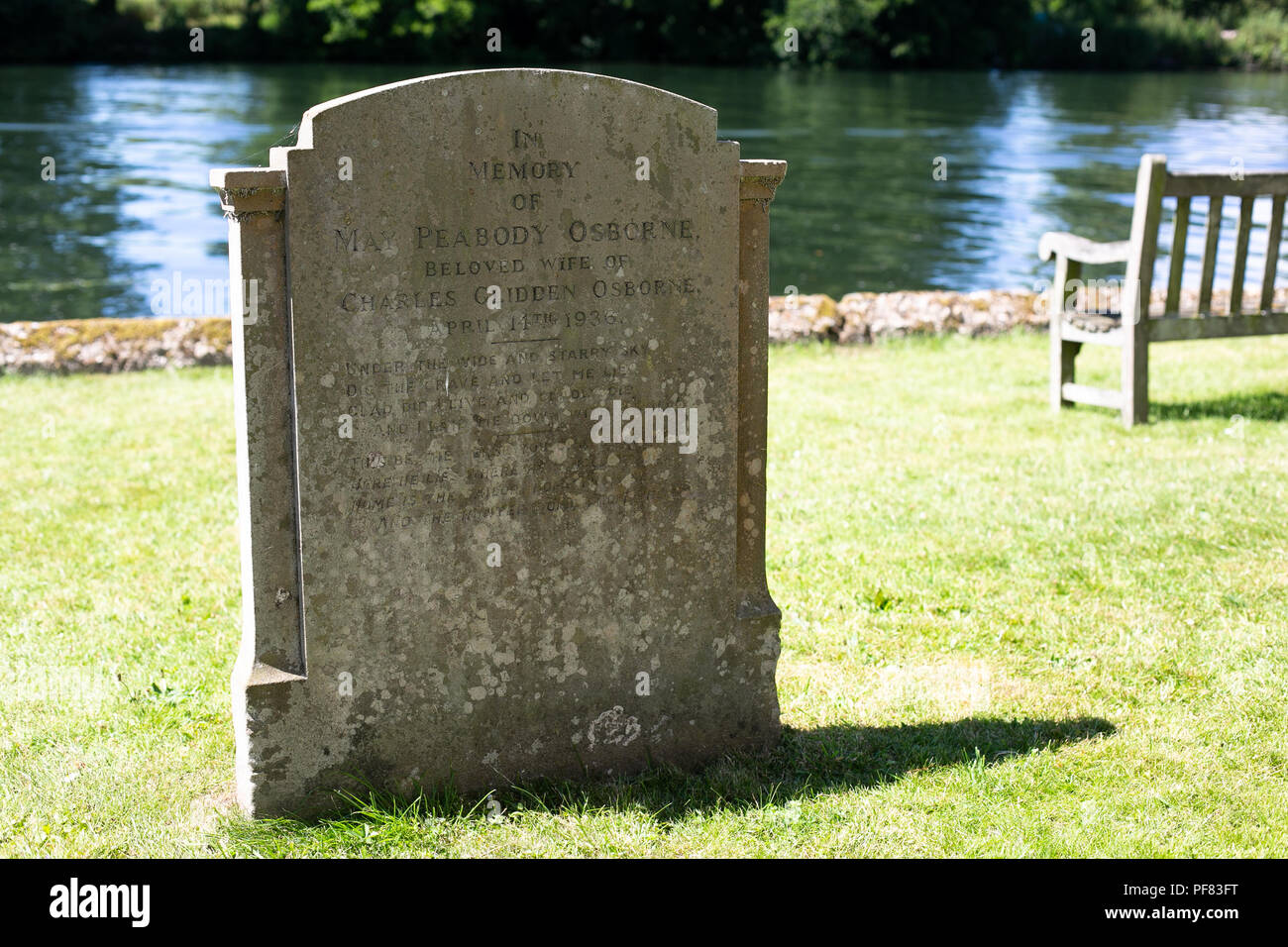 Landscape shot of a tombstone in a graveyard in an english village ...