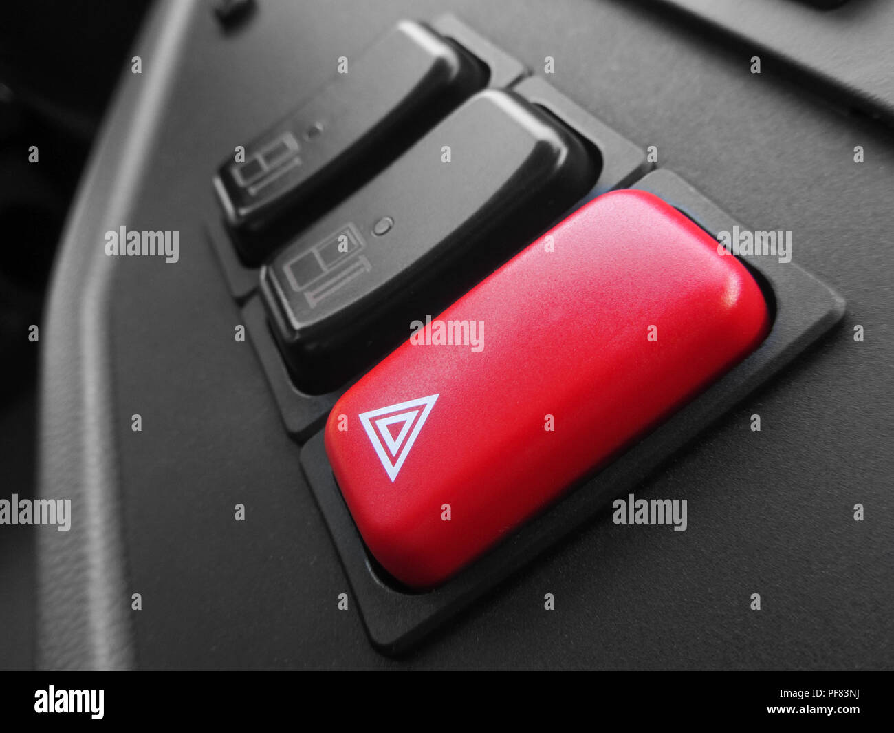 Focus over a red emergency triangle button inside a bus Stock Photo - Alamy