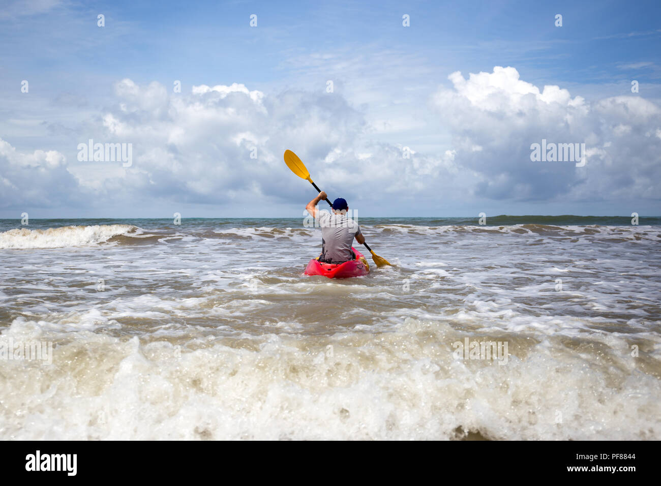 Man doing kayak surfing in the sea on vacation Stock Photo - Alamy