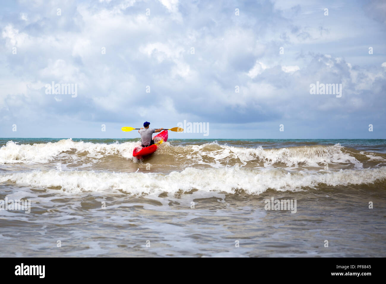 Man doing kayak surfing in the sea on vacation Stock Photo - Alamy