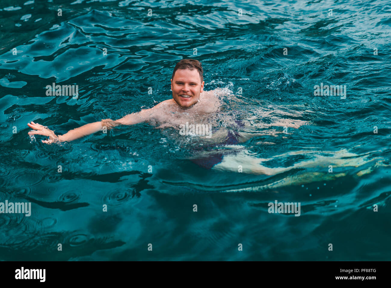 man swimming in blue transparent sea water. summer vacation Stock Photo ...