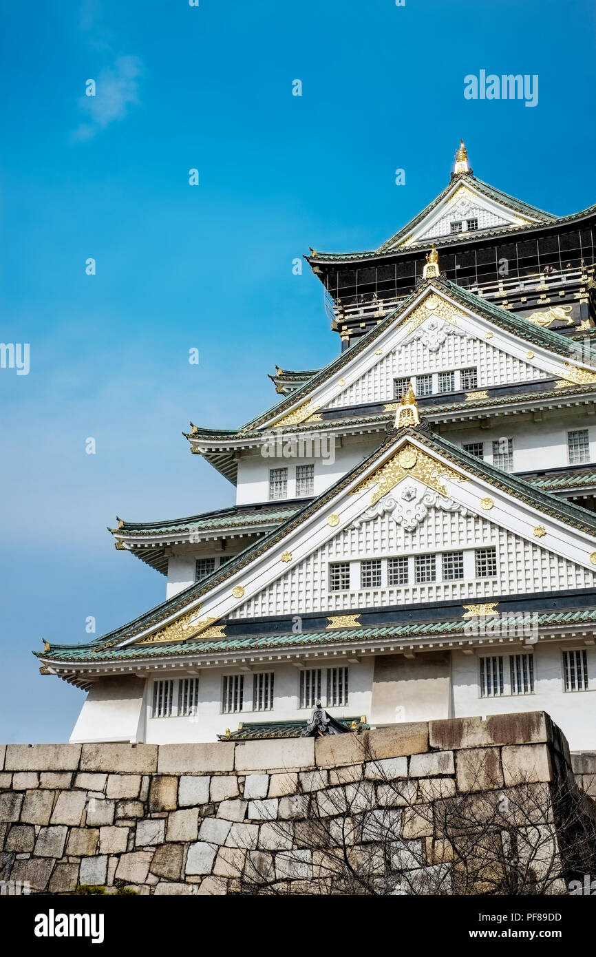 The famous heritage, Osaka castle under bright blue dramatic cloudy sky ...