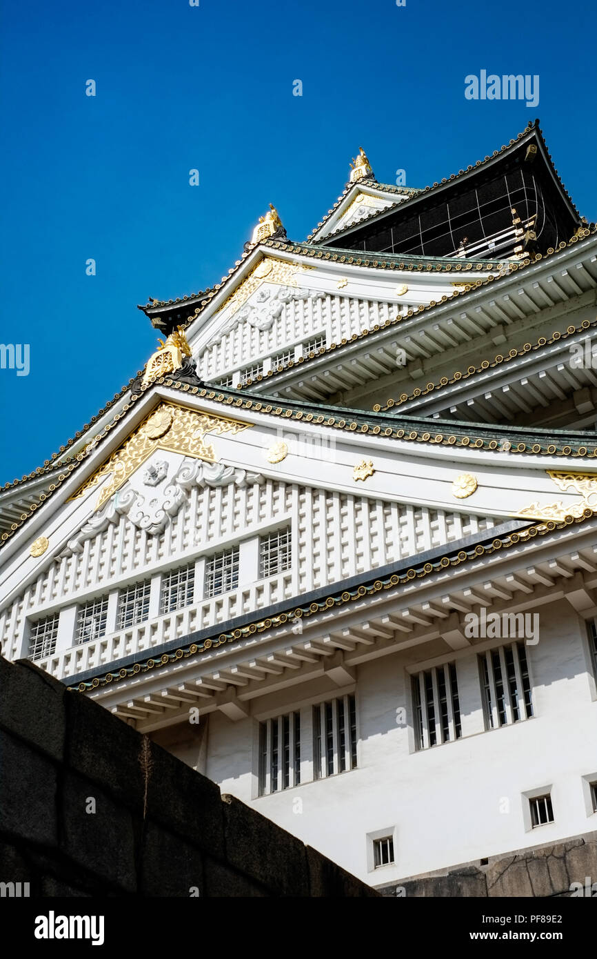 The famous heritage, Osaka castle under bright blue dramatic cloudy sky ...