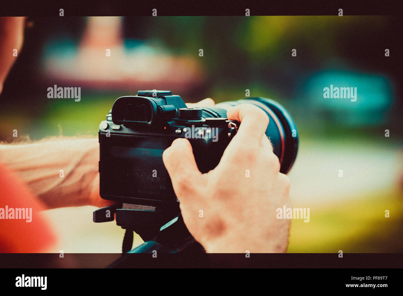 Travel videographer with camera in hand working outdoor Stock Photo - Alamy