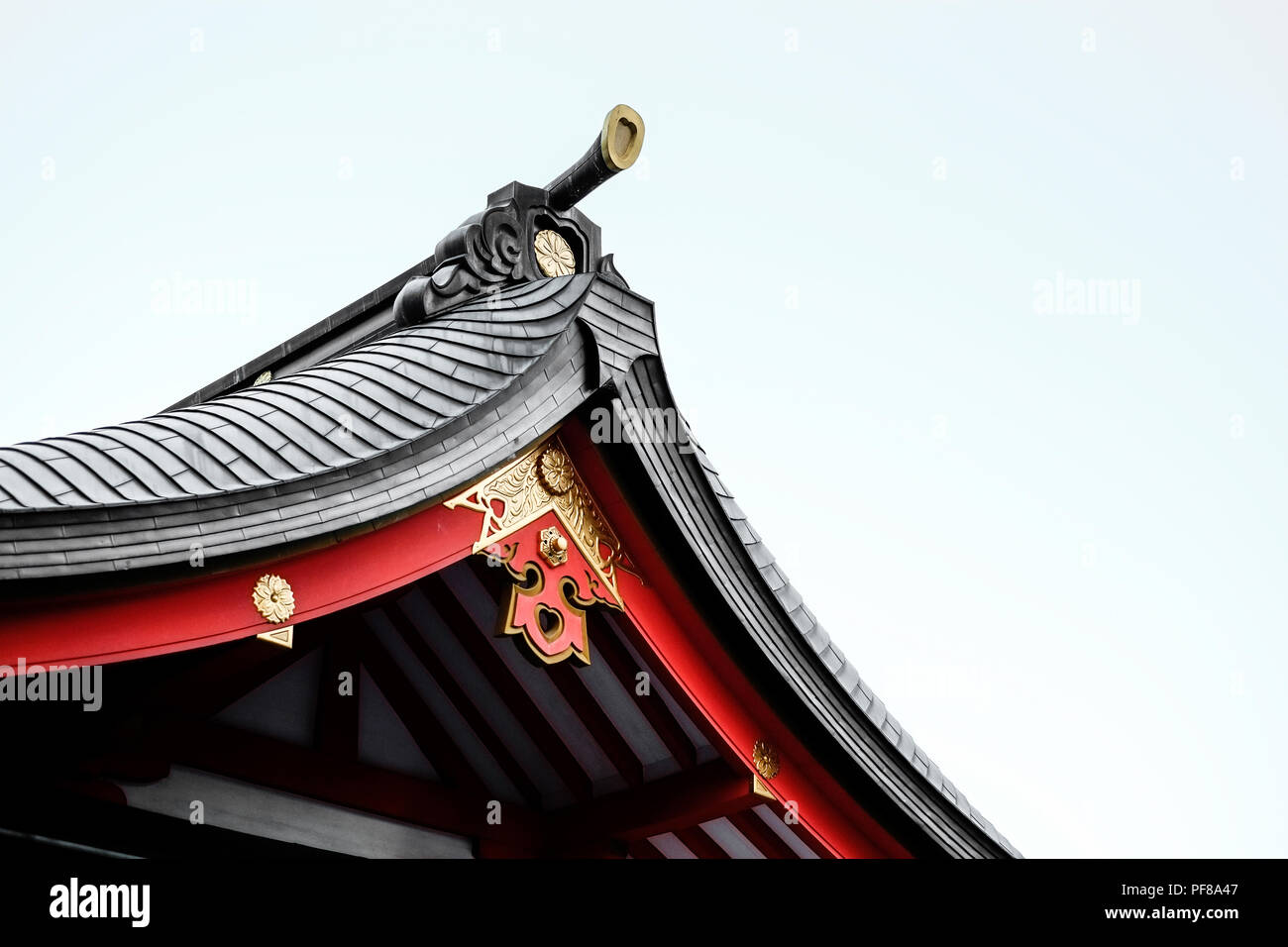 Japanese traditional temple with golden red roof under blue sky in ...