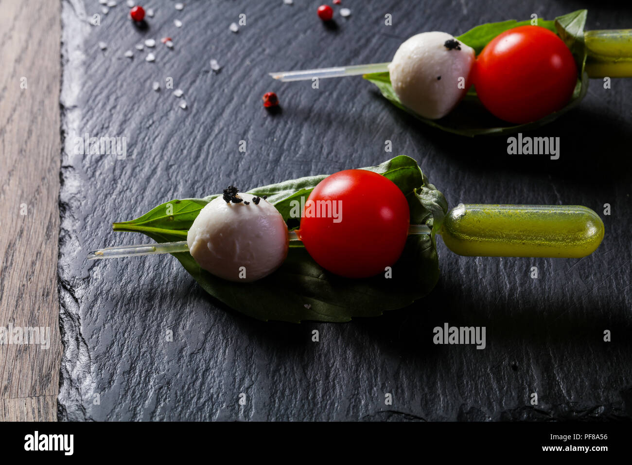 Canape caprese with olive oil Stock Photo - Alamy