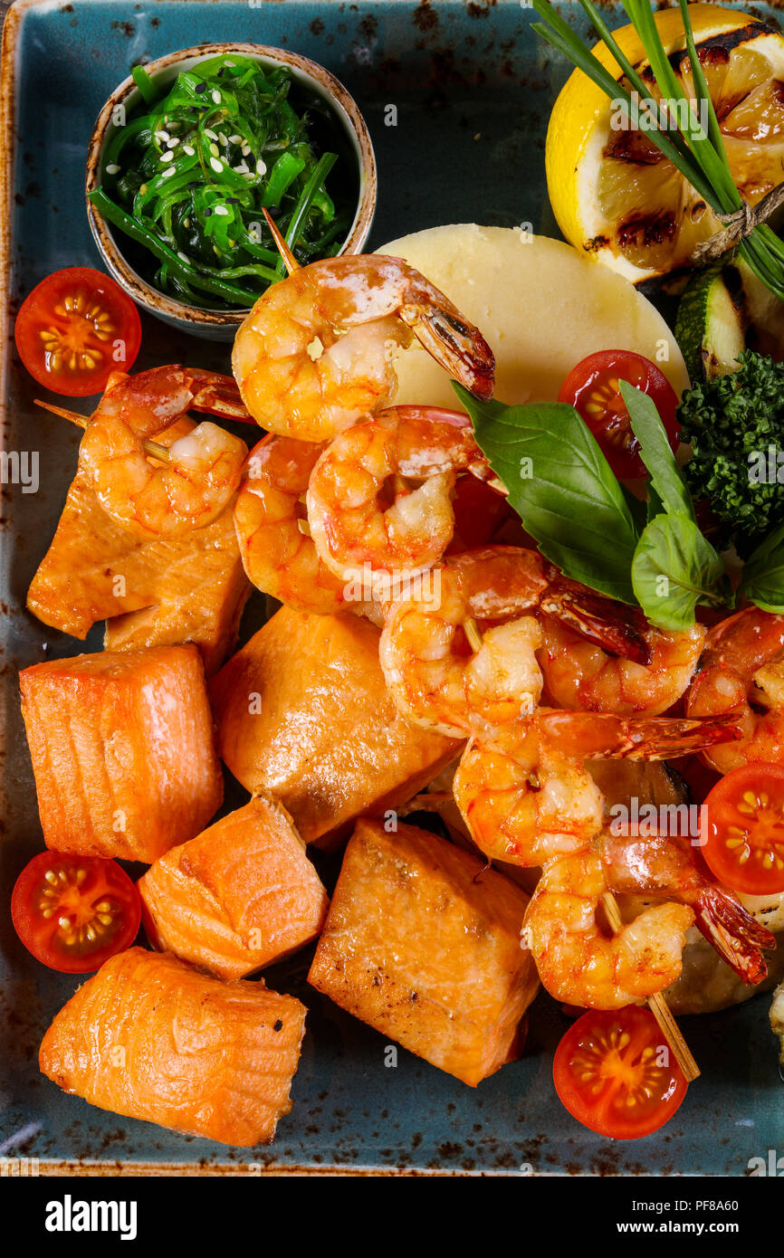 Fish and prawn plate served grilled vegetables Stock Photo - Alamy