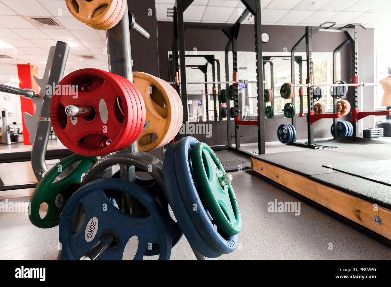 Gym interior with weight plates close up Stock Photo - Alamy