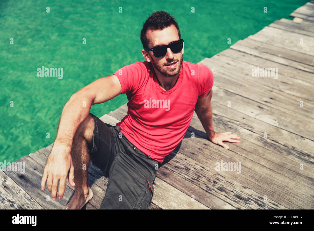 Young men sunbathing beach hi-res stock photography and images - Alamy